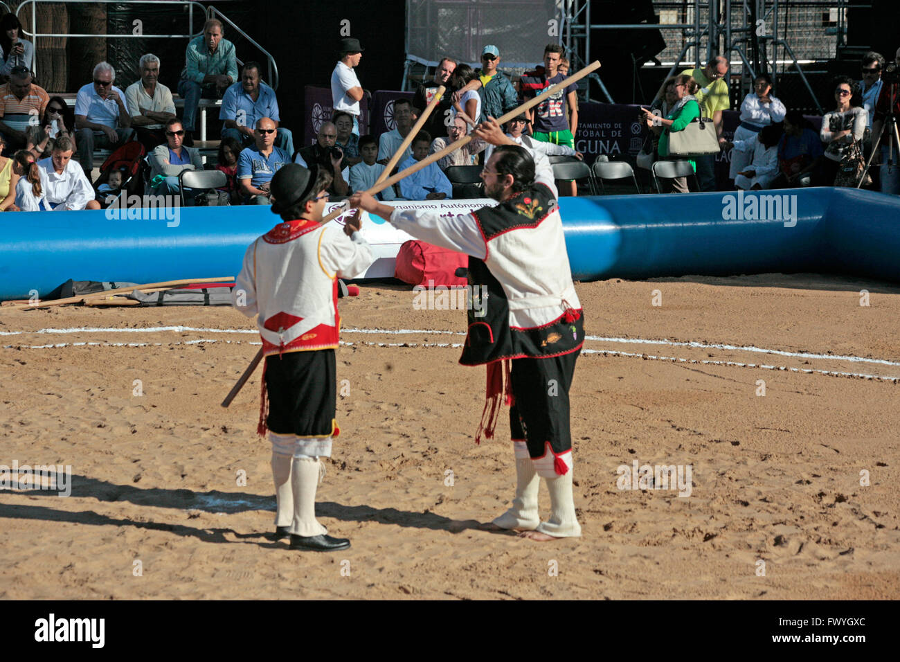 Teens playing the canarian stick wrestling in a public exhibition in ...