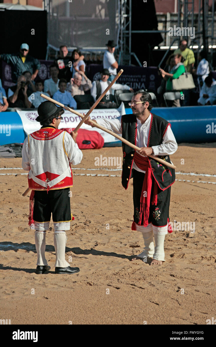 men playing the canarian stick wrestling in a public exhibition in the ...