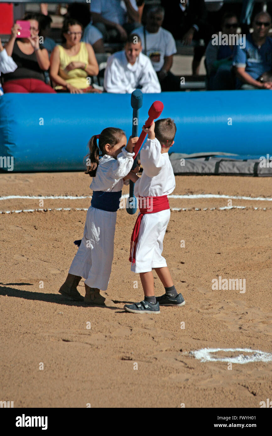 Little kids playing the canarian stick wrestling in a public exhibition ...