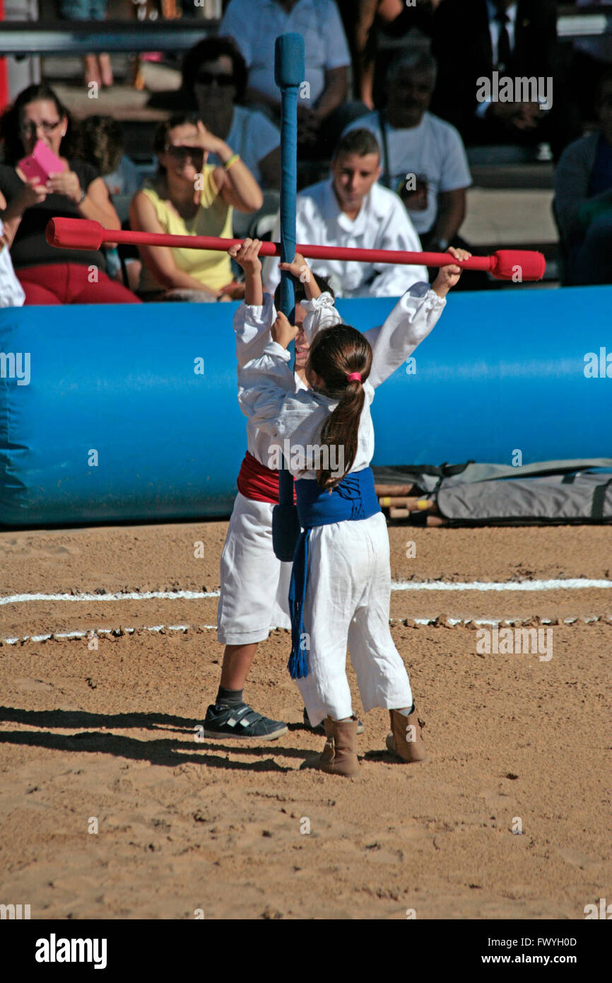 Teens playing the canarian stick wrestling in a public exhibition in ...