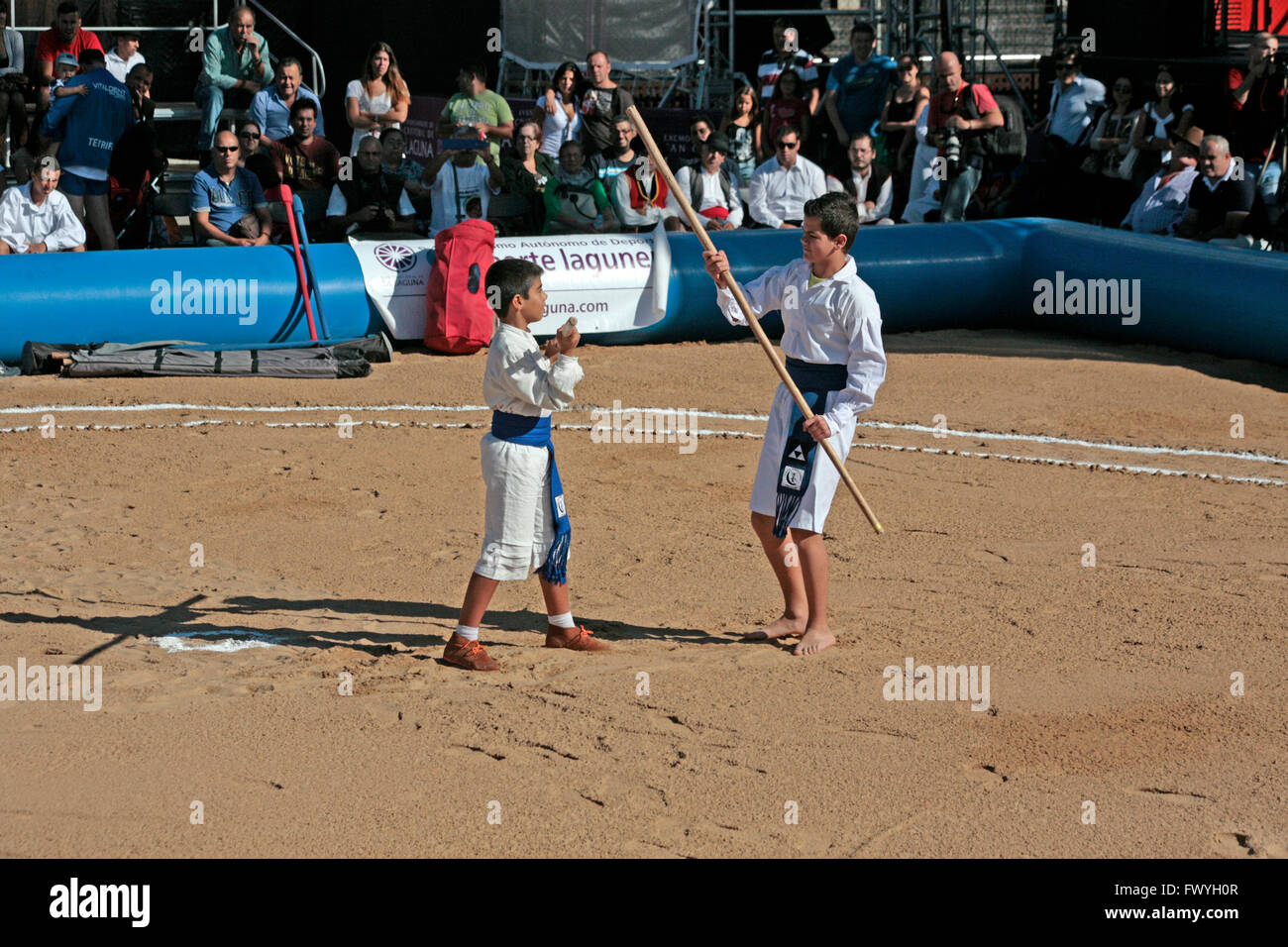 Teens playing the canarian stick wrestling in a public exhibition in ...