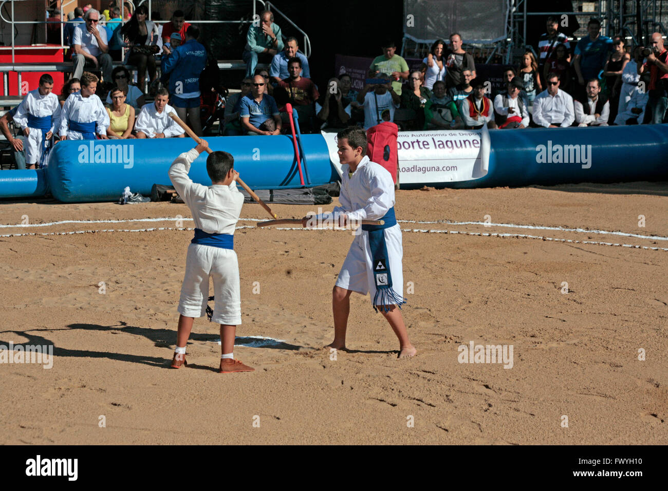 Teens playing the canarian stick wrestling in a public exhibition in ...