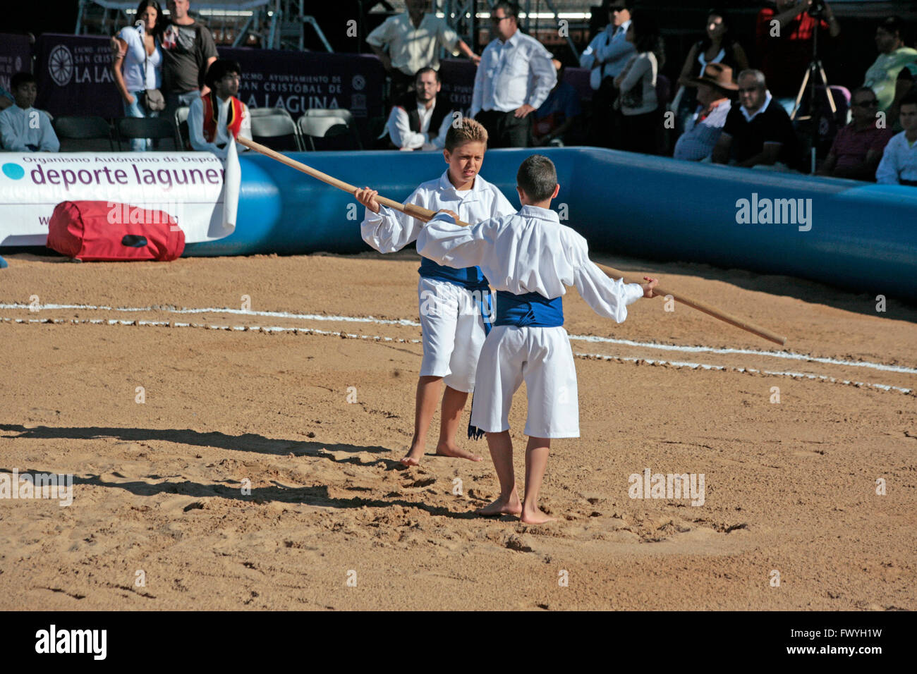 Teens playing the canarian stick wrestling in a public exhibition in ...