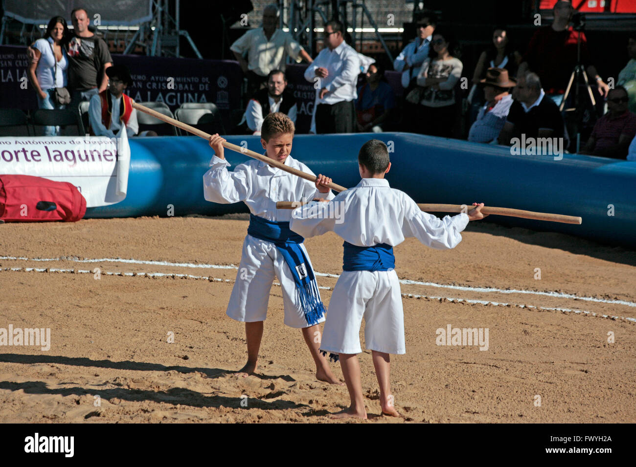 Teens playing the canarian stick wrestling in a public exhibition in ...