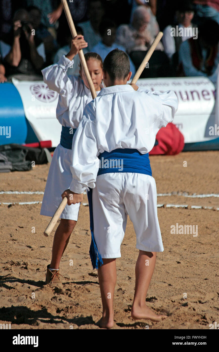 Teens playing the canarian stick wrestling in a public exhibition in ...