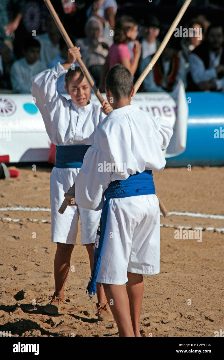 Teens playing the canarian stick wrestling in a public exhibition in ...