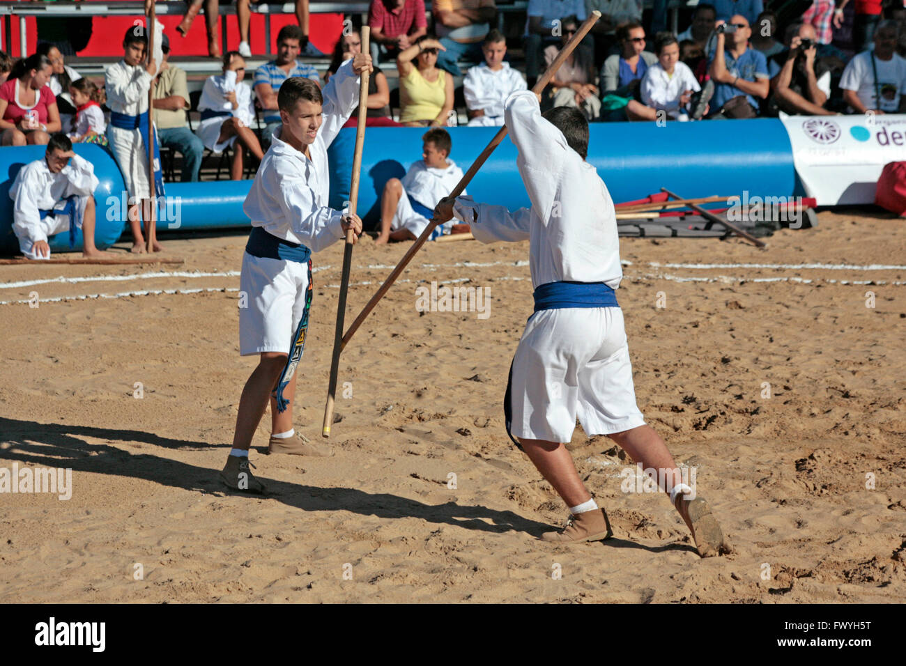 Teens playing the canarian stick wrestling in a public exhibition in ...