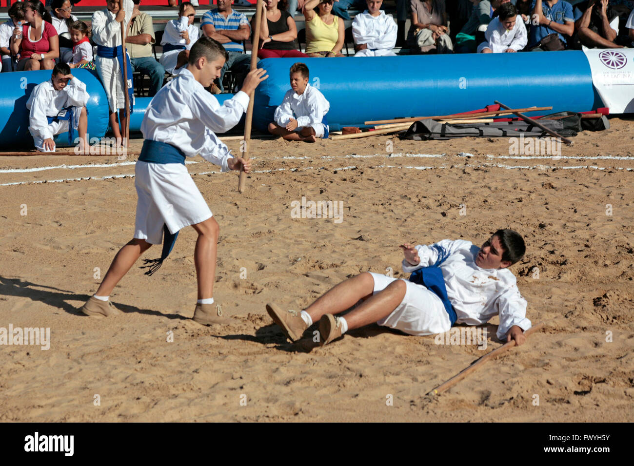Teens playing the canarian stick wrestling in a public exhibition in ...