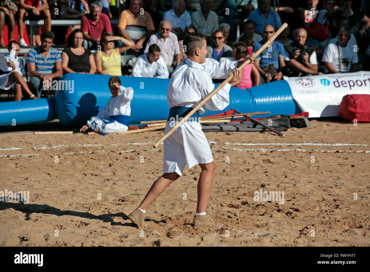 Teens playing the canarian stick wrestling in a public exhibition in ...