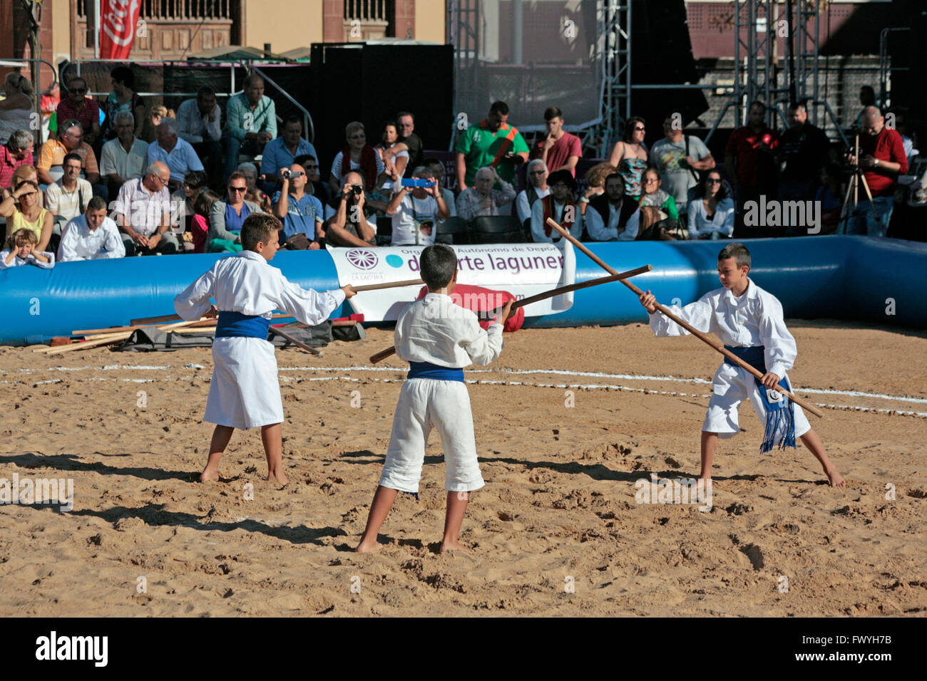 Teens playing the canarian stick wrestling in a public exhibition in ...