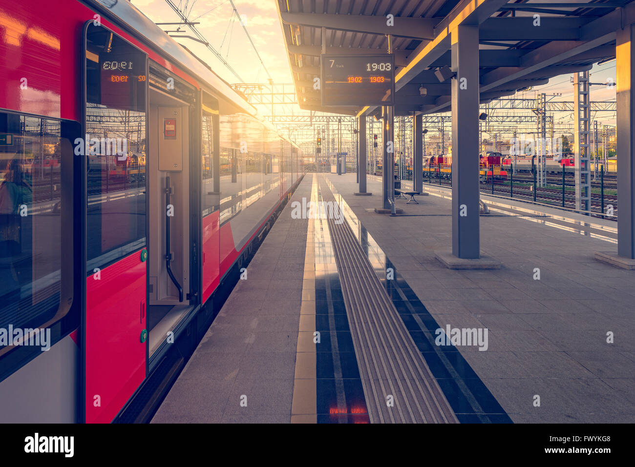 Train stands by the platform at sunset time Stock Photo - Alamy