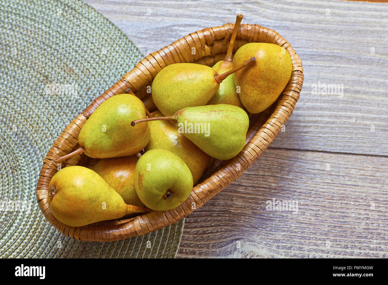 Pears in basket on table Stock Photo - Alamy
