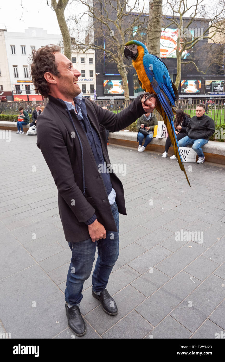 Performer with a parrot at Leicester Square Garden, London England ...