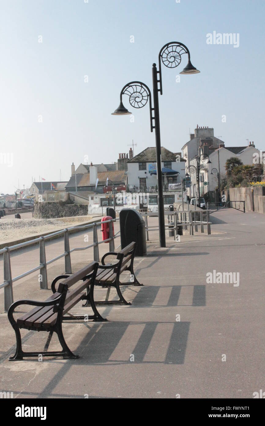 Lyme Regis seafront benches and fossil ammonite lights Stock Photo - Alamy