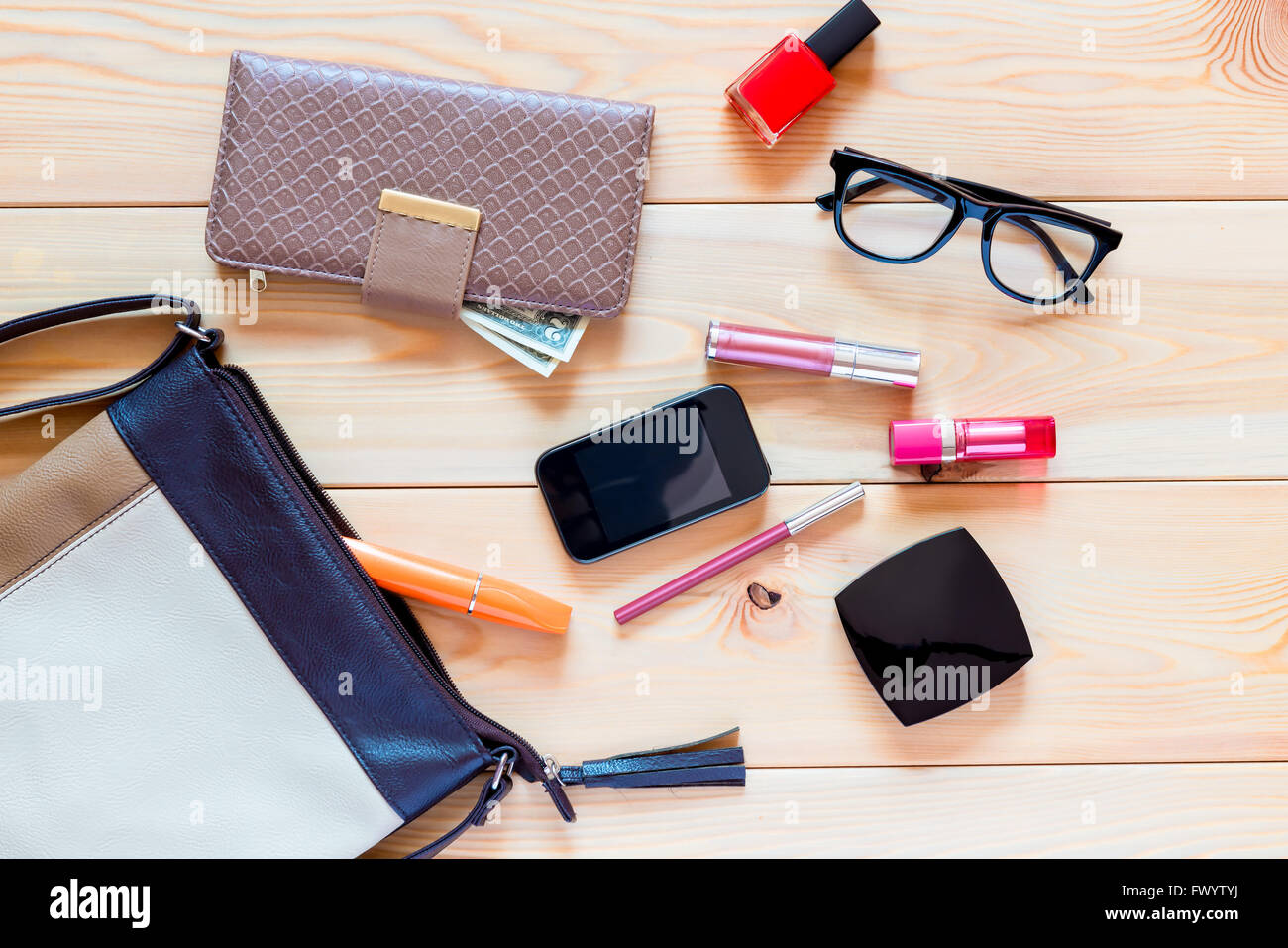 the contents of women's handbags are scattered on the floor Stock Photo ...