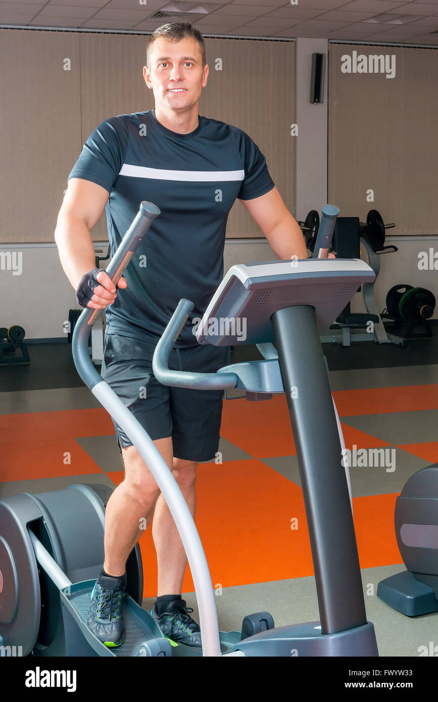 portrait of a man in the gym on the simulator Stock Photo - Alamy
