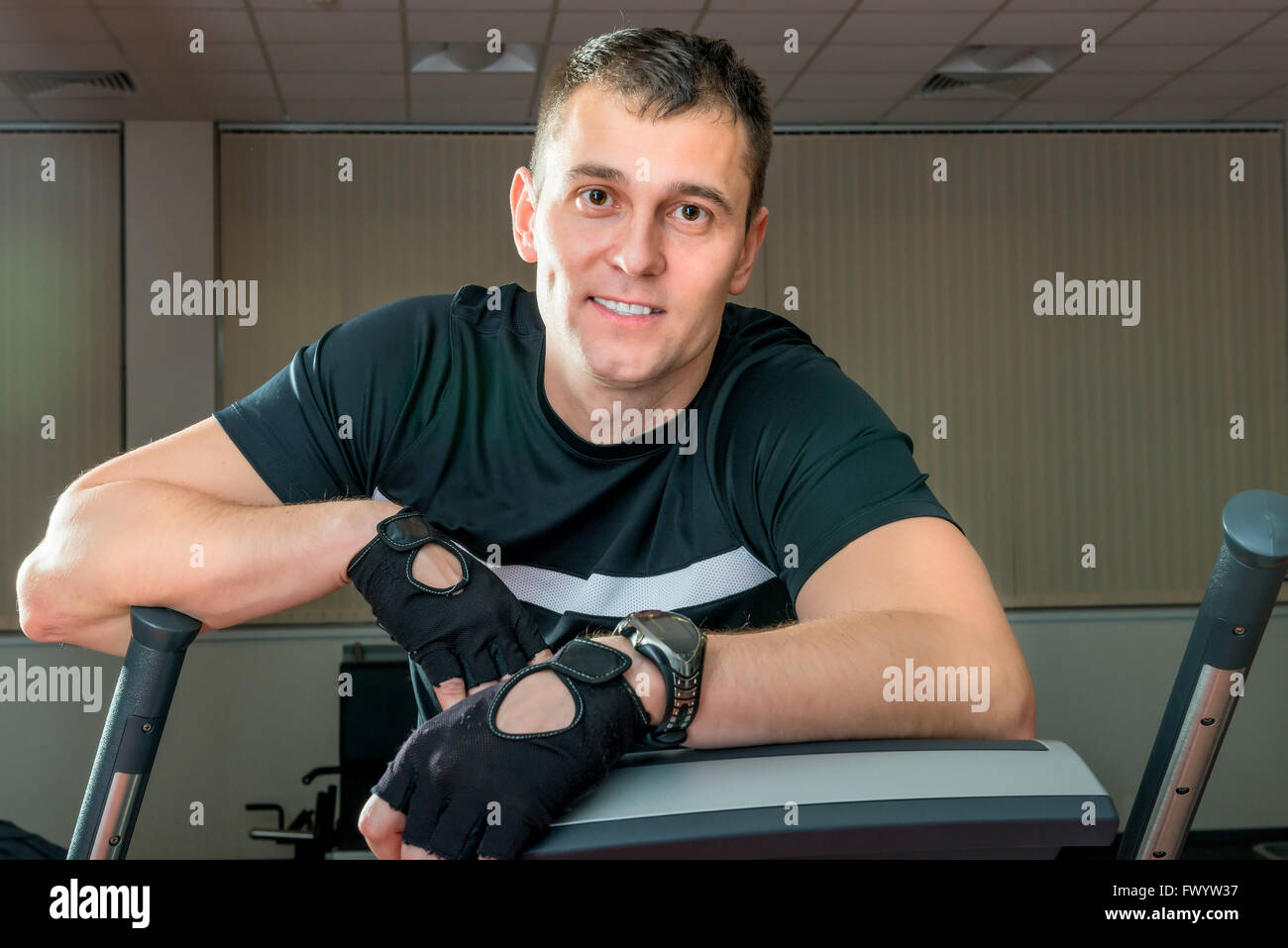 strong young man at the gym on a simulator posing Stock Photo - Alamy