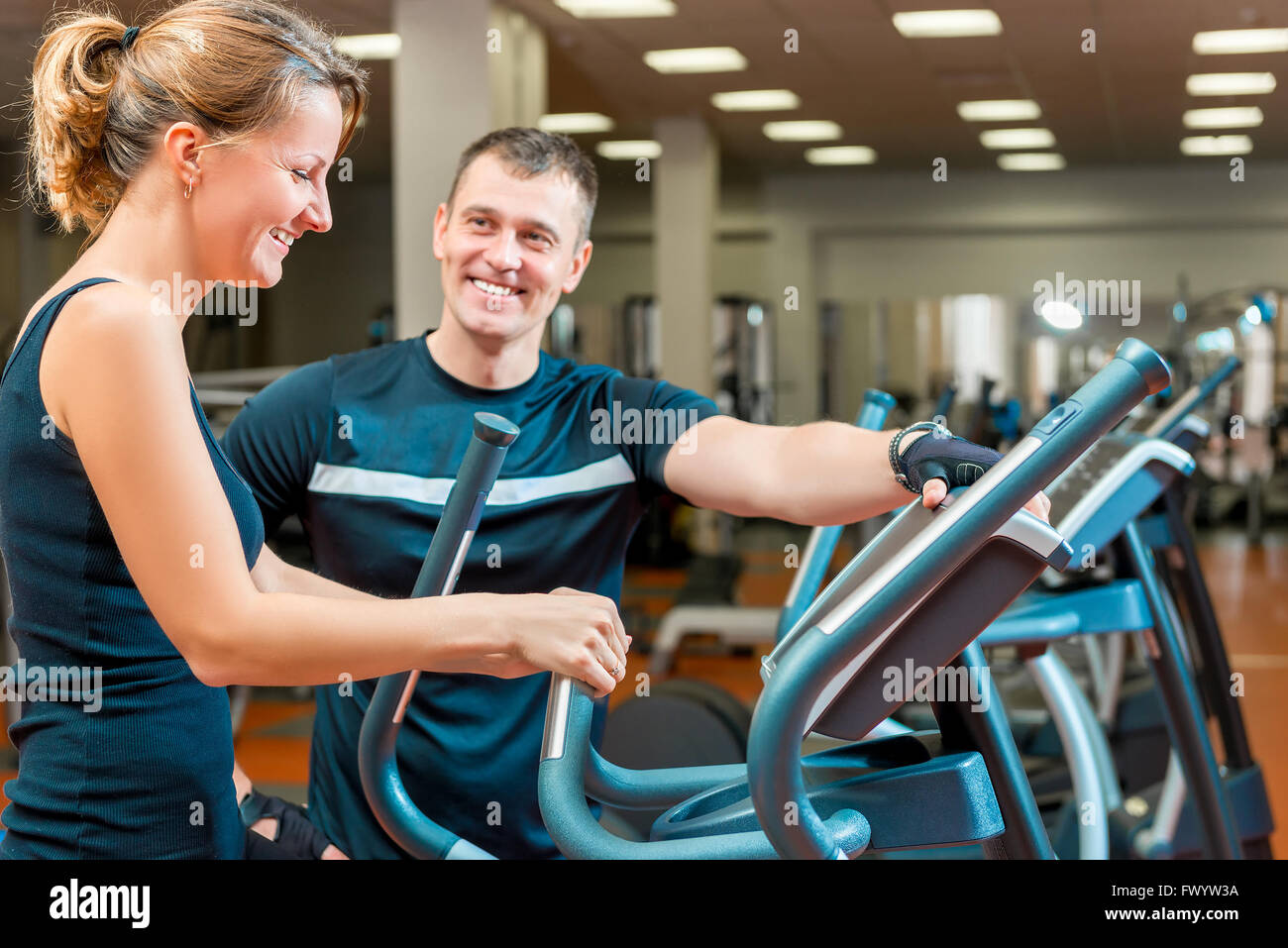 coach and a young girl in the gym exercise Stock Photo - Alamy