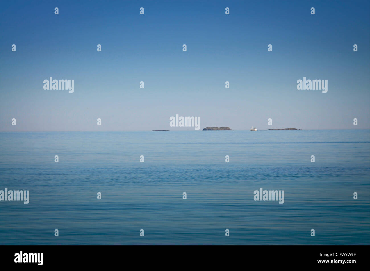 Fishing boat between two tiny islands at the coast of the North ...