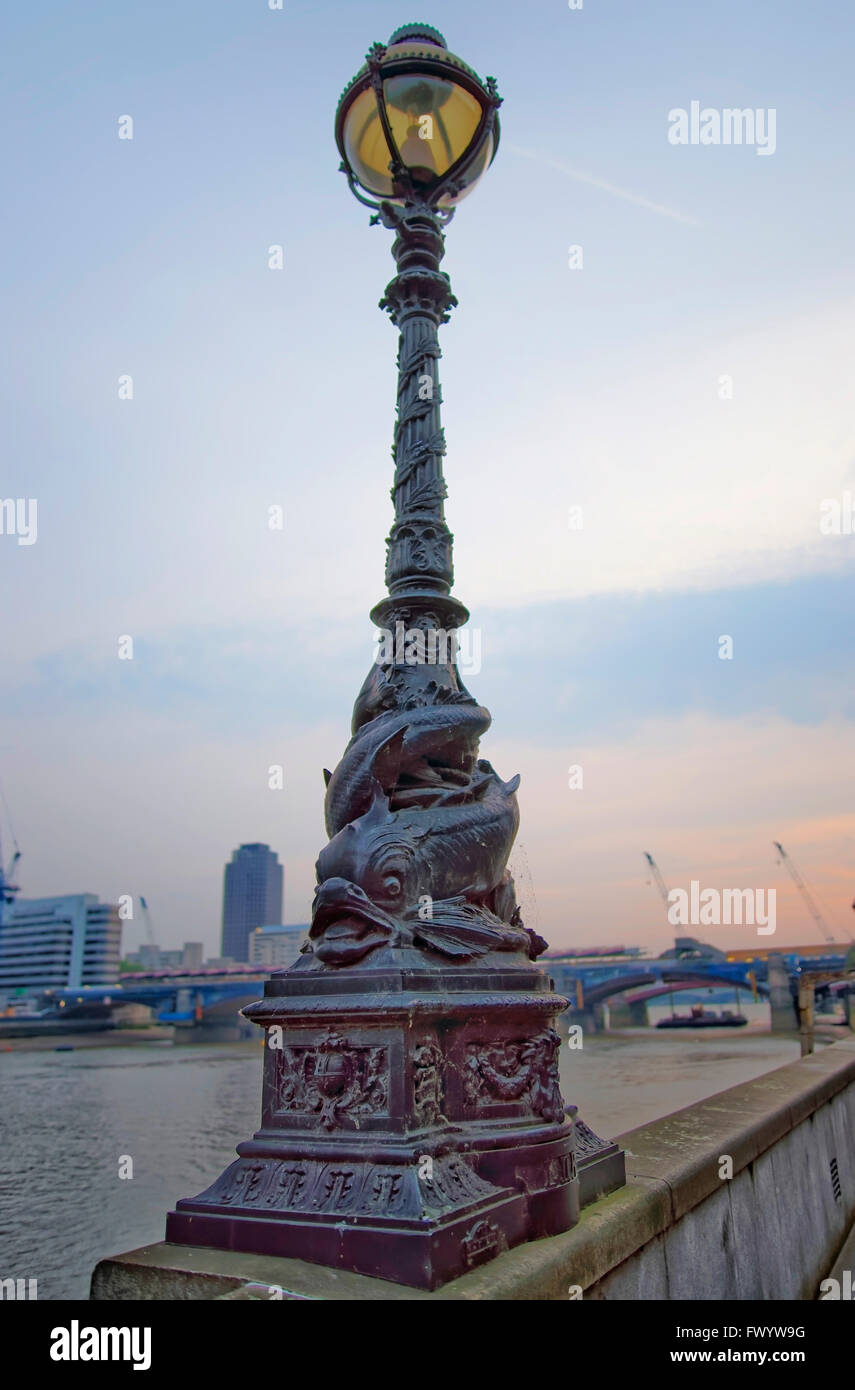 Dolphin lamp standard on Thames Embankment in London in England. The ...