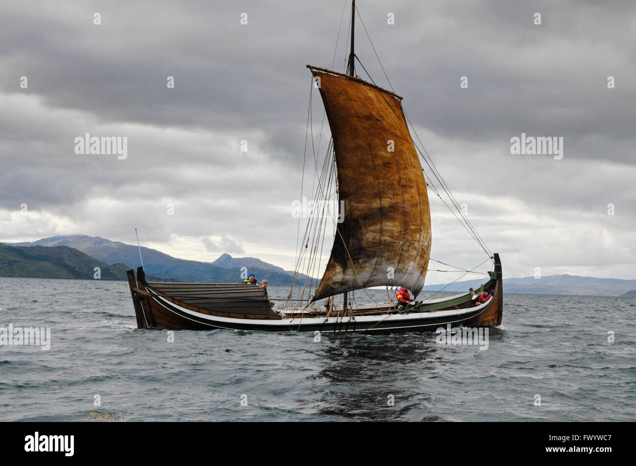 A traditional wooden Nordland boat is sailing on Ofotfjorden in ...