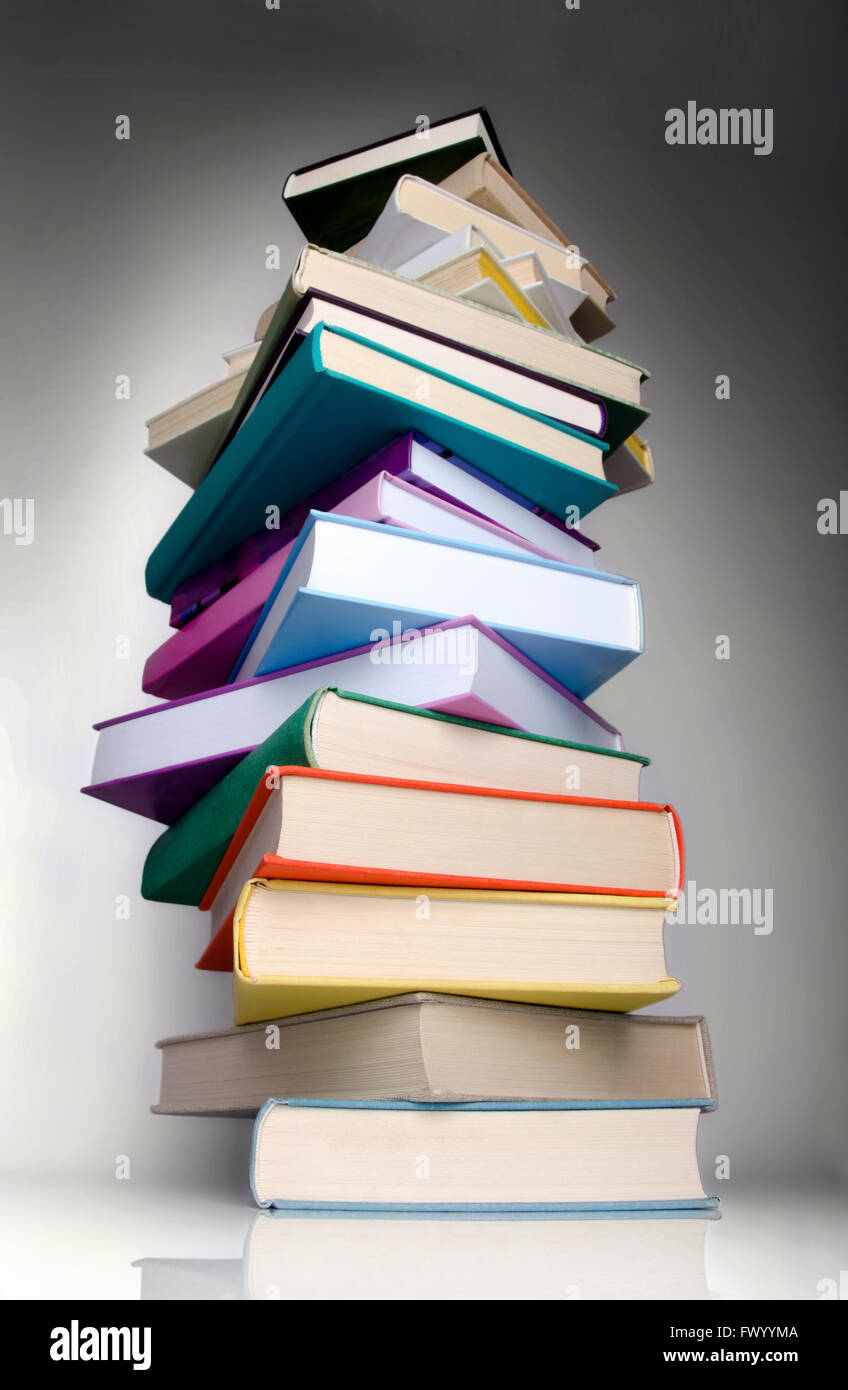 Huge column of books isolated on retro style background Stock Photo - Alamy