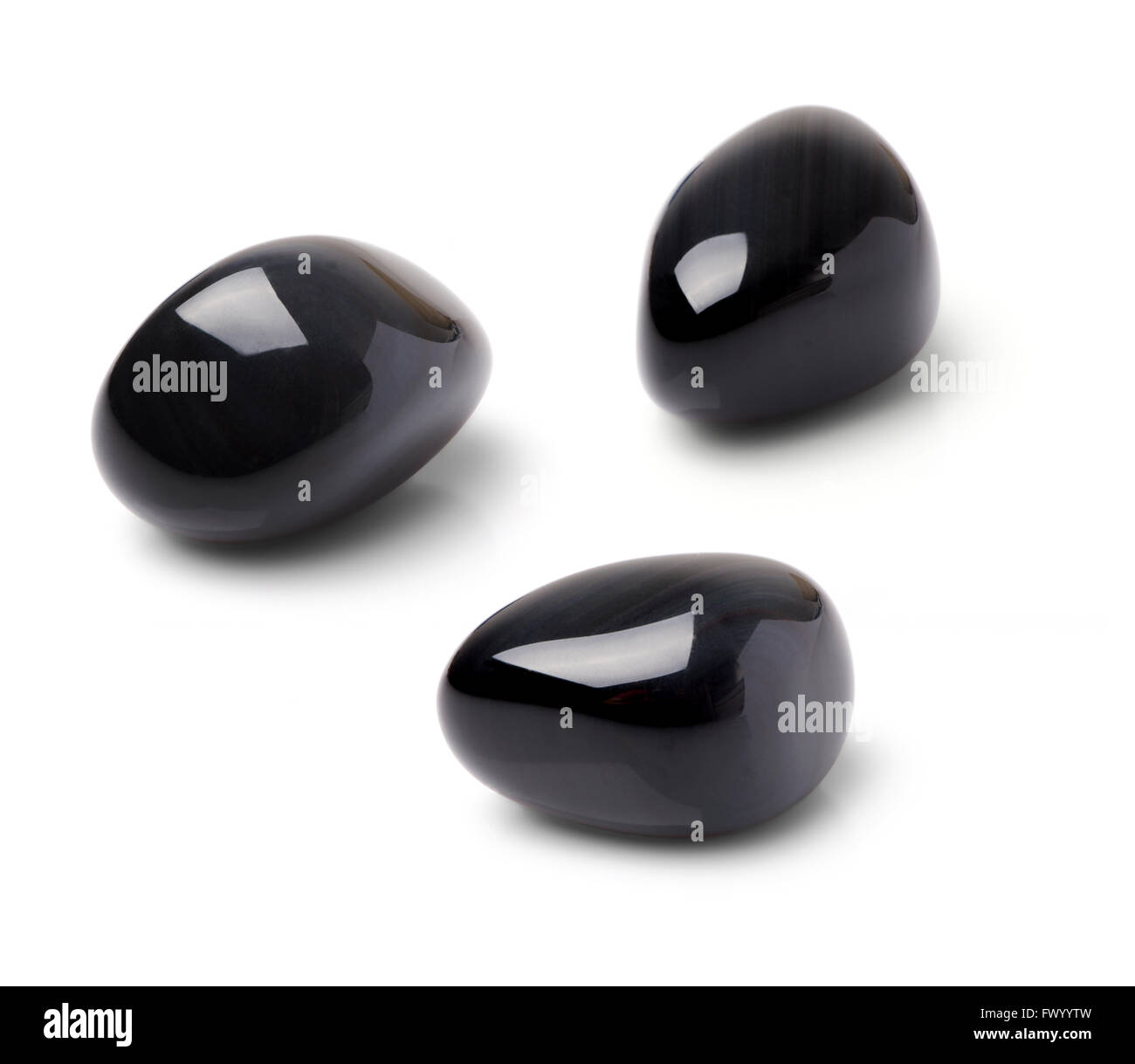 Shiny obsidian shot from three points of view isolated on white ...