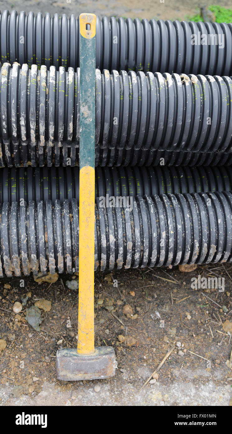 big bat very heavy and plastic tubes in road construction Stock Photo ...