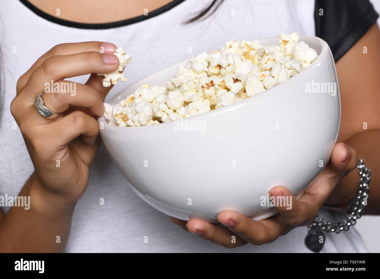 Young beautiful woman eating popcorn. Isolated white background Stock ...