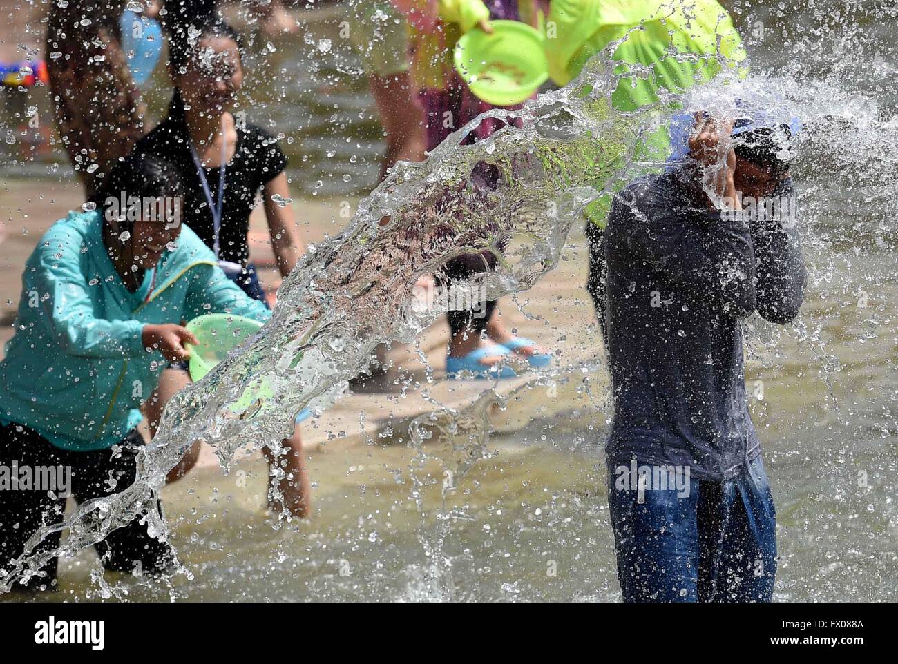Kunming, China's Yunnan Province. 9th Apr, 2016. People sprinkle water ...