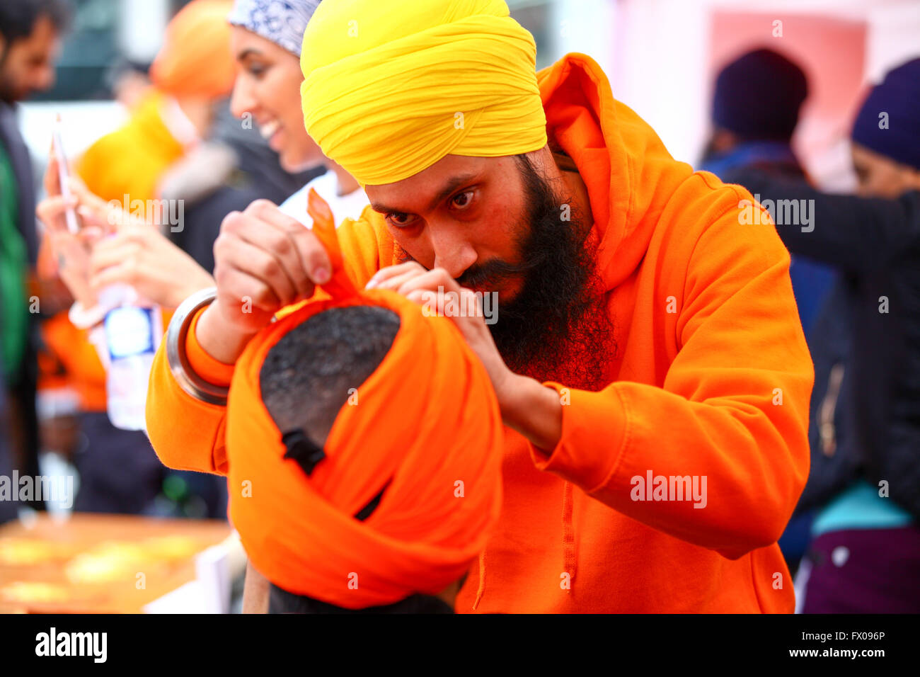 City Hall, London, UK. 9 April 2016. A man has his head wrapped by a ...