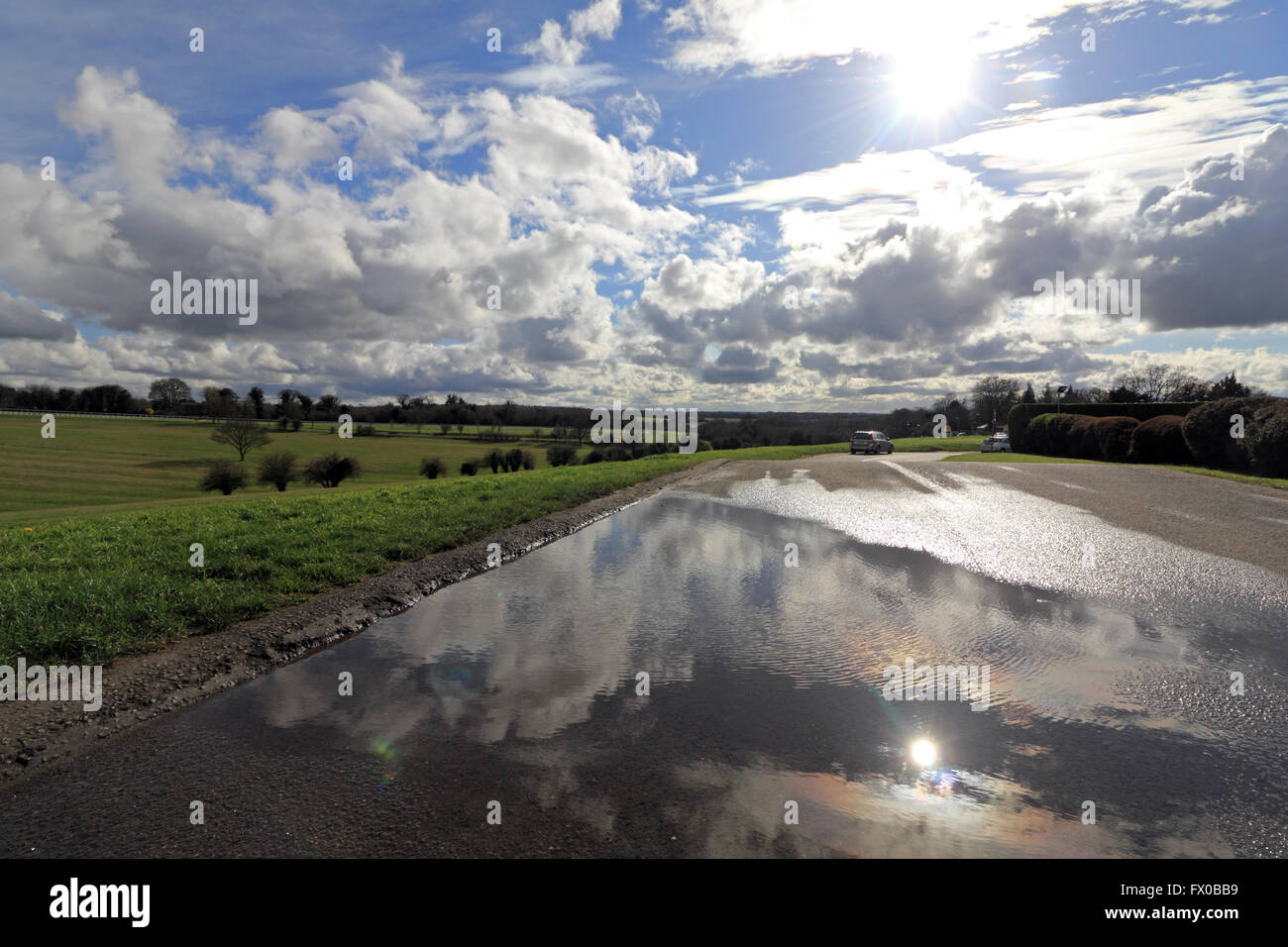 Reflection of sun and clouds in a puddle High Resolution Stock ...