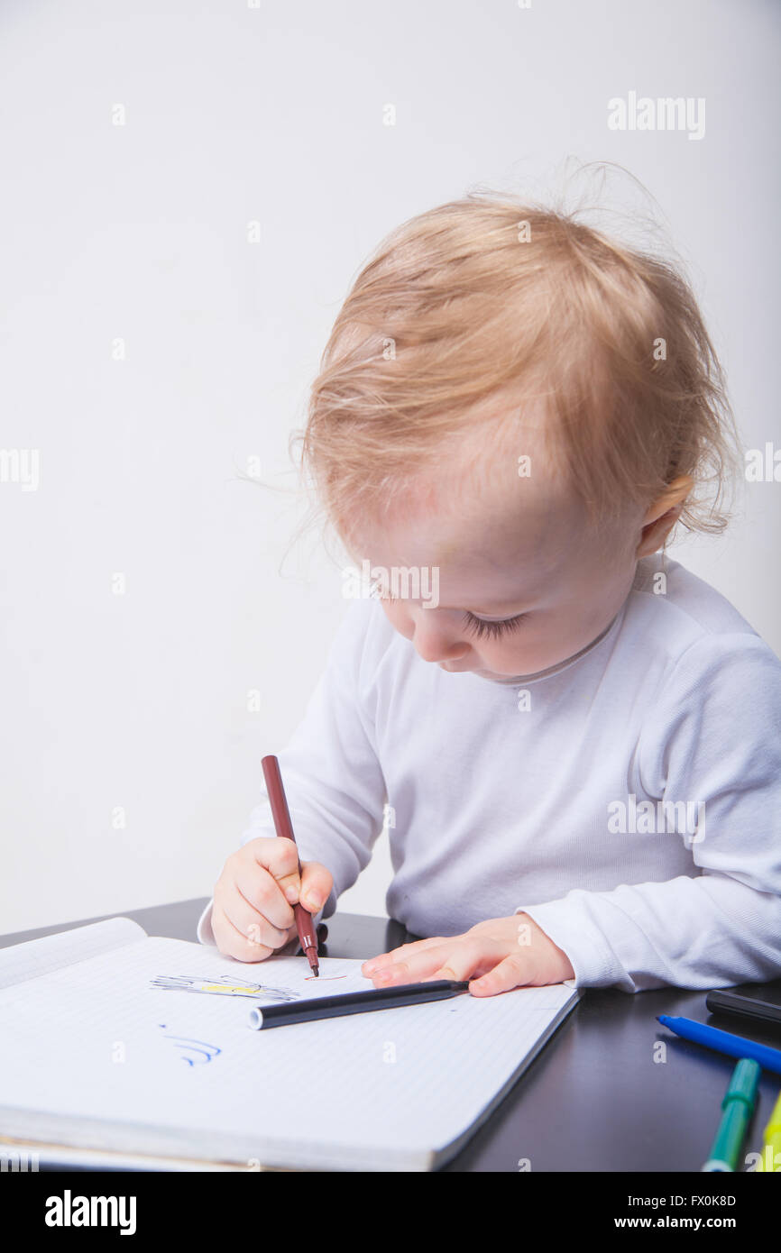 Baby girl drawing with colorful felt-tip pens on white background Stock ...