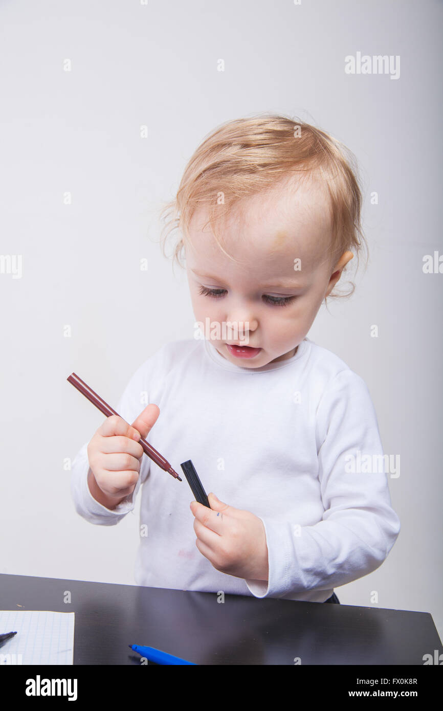 Baby girl drawing with colorful felt-tip pens on white background Stock ...