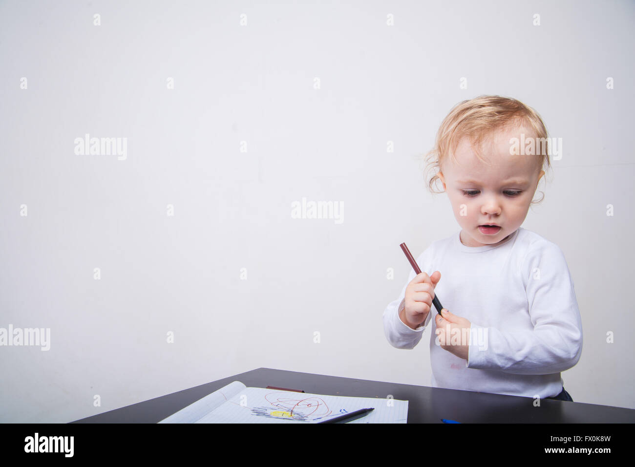 Baby girl drawing with colorful felt-tip pens on white background Stock ...