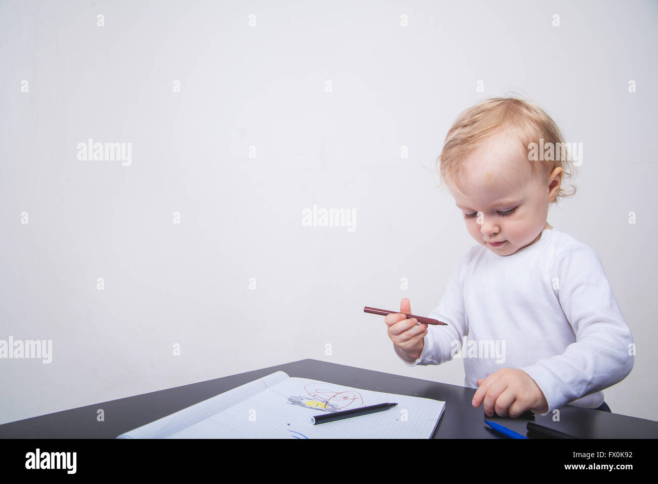 Baby girl drawing with colorful felt-tip pens on white background Stock ...