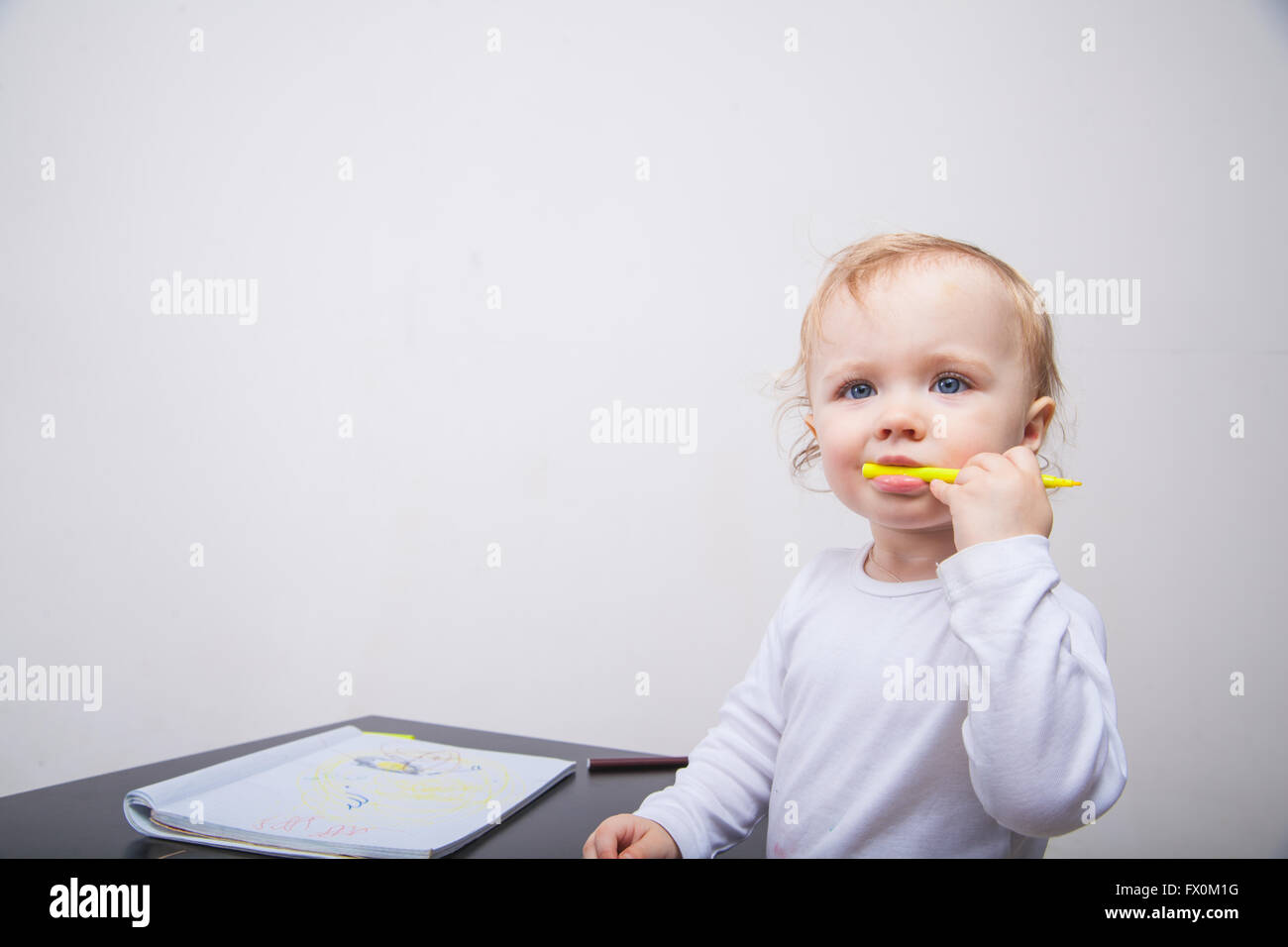Baby girl drawing with colorful felt-tip pens on white background Stock ...