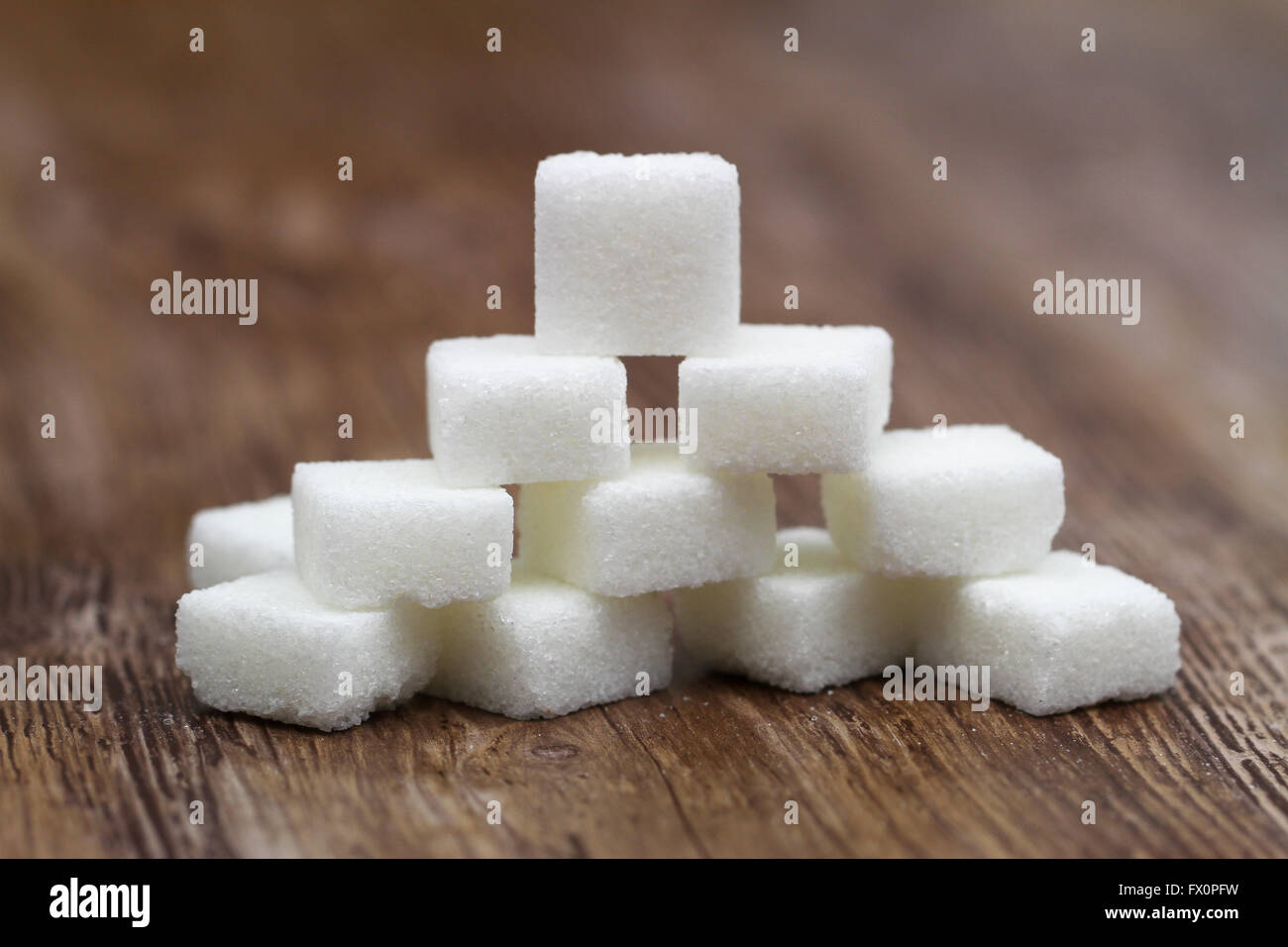 Stack of white sugar cubes on wooden surface Stock Photo - Alamy