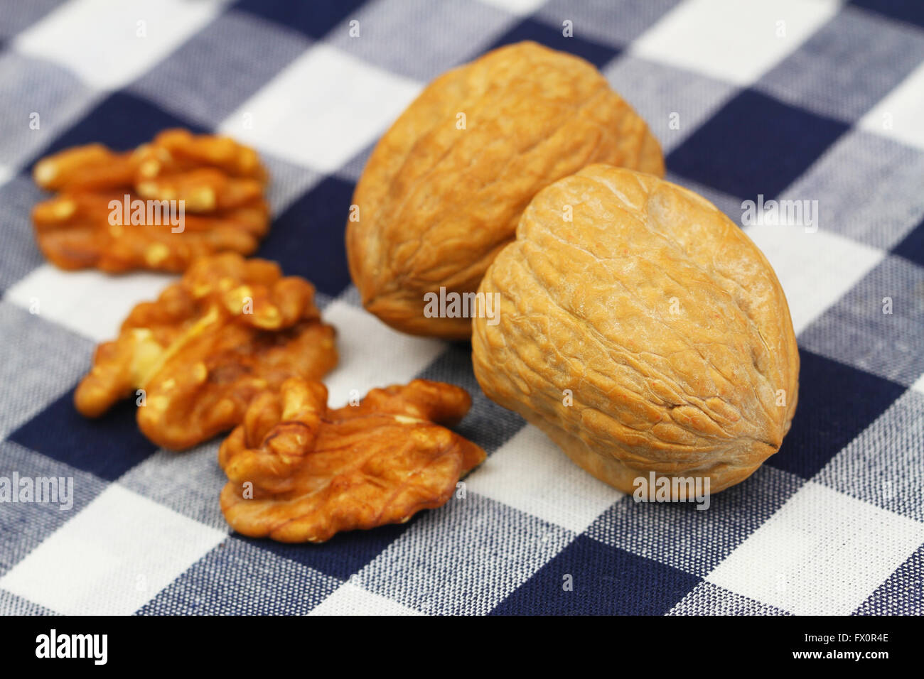 Walnuts with and without shell on checkered cloth, closeup Stock Photo ...