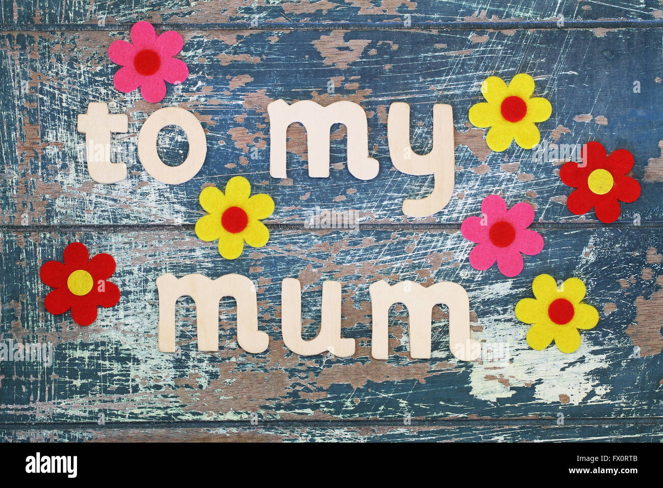 To my mum written with wooden letters on rustic surface with colorful ...