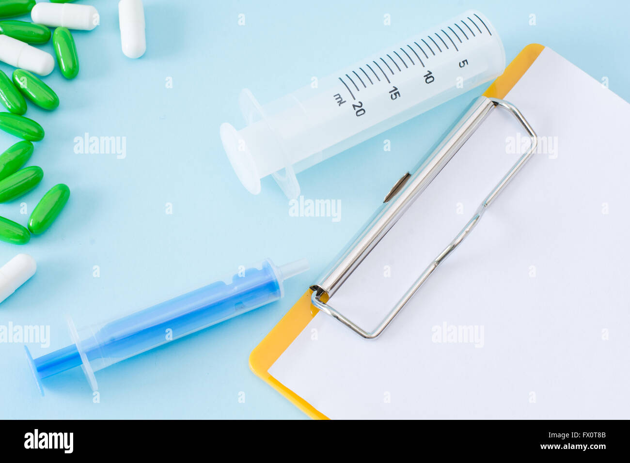 Medical conceptual picture with pills, injection, empty clipboard sheet ...