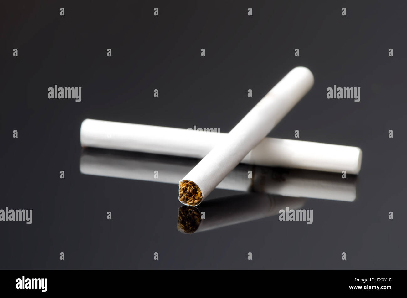Two white cigarettes with reflection on black background Stock Photo ...