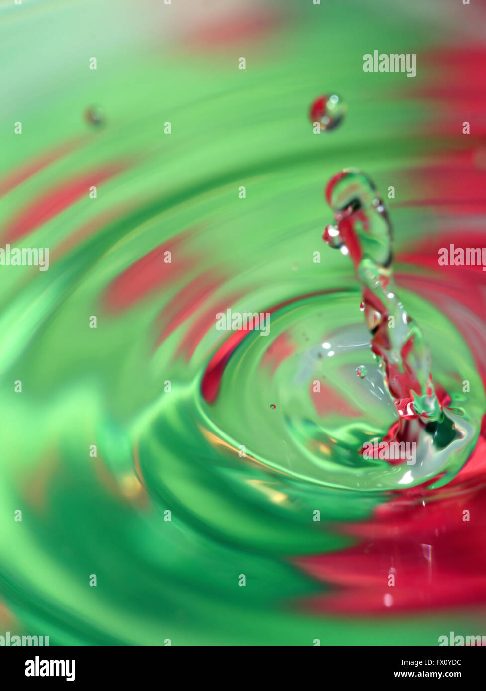 Falling water drop and nice splash on colorful background Stock Photo ...