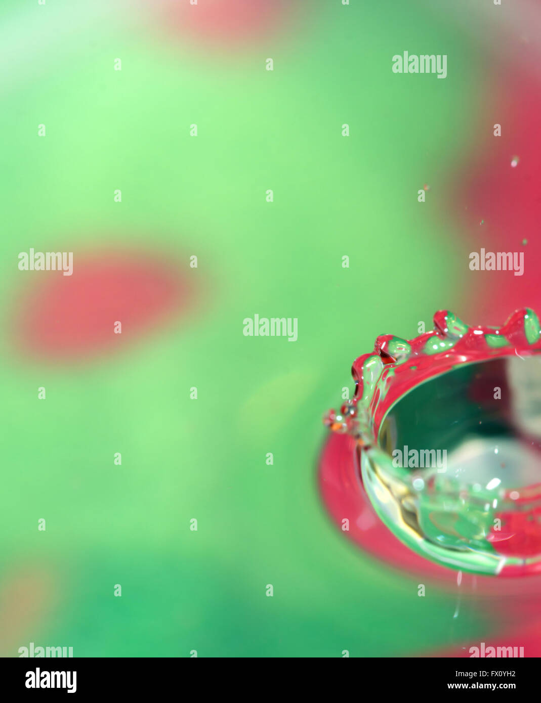 Falling water drop and nice splash on colorful background Stock Photo ...