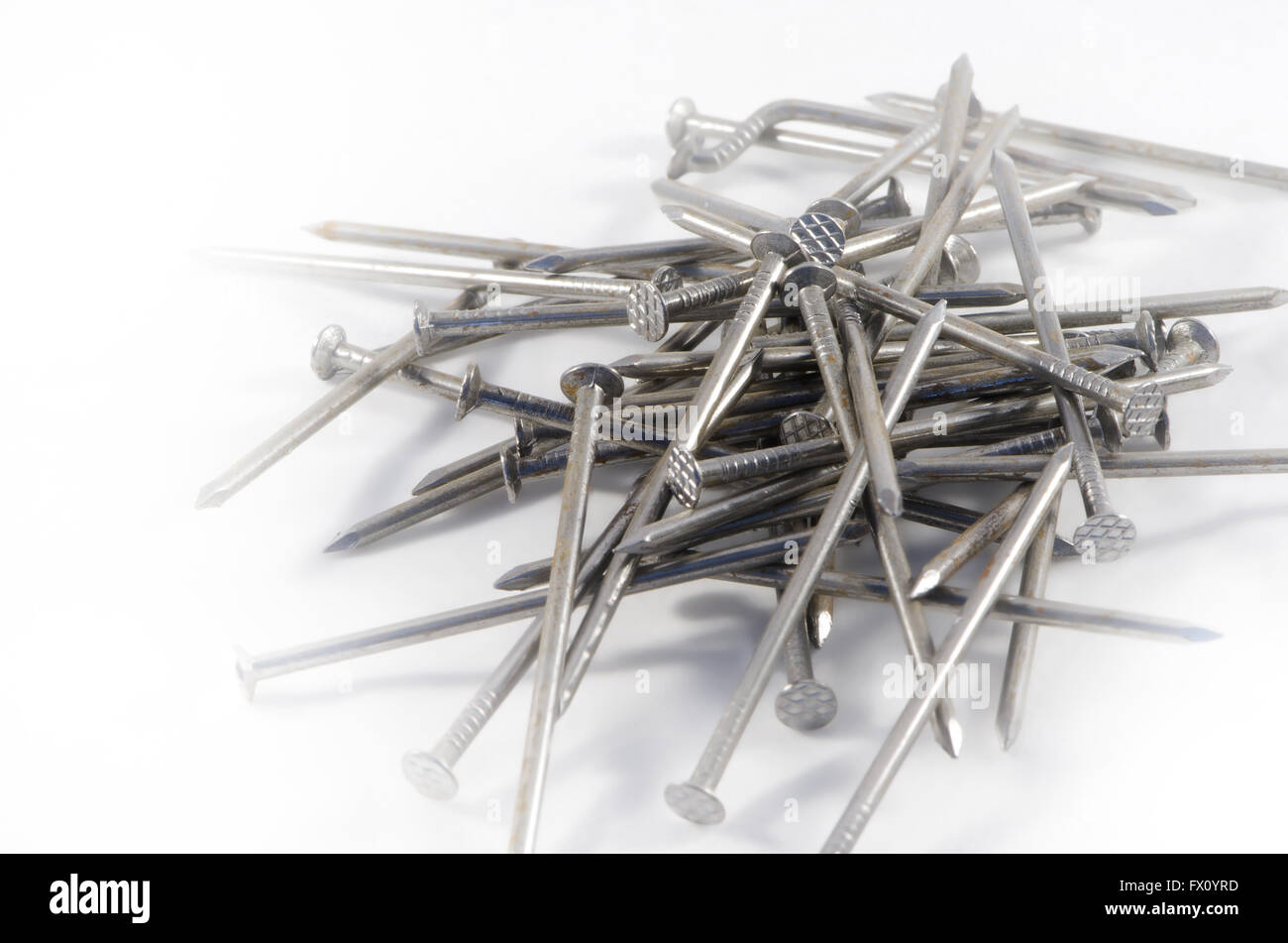 Heap of iron nails isolated on white background Stock Photo - Alamy