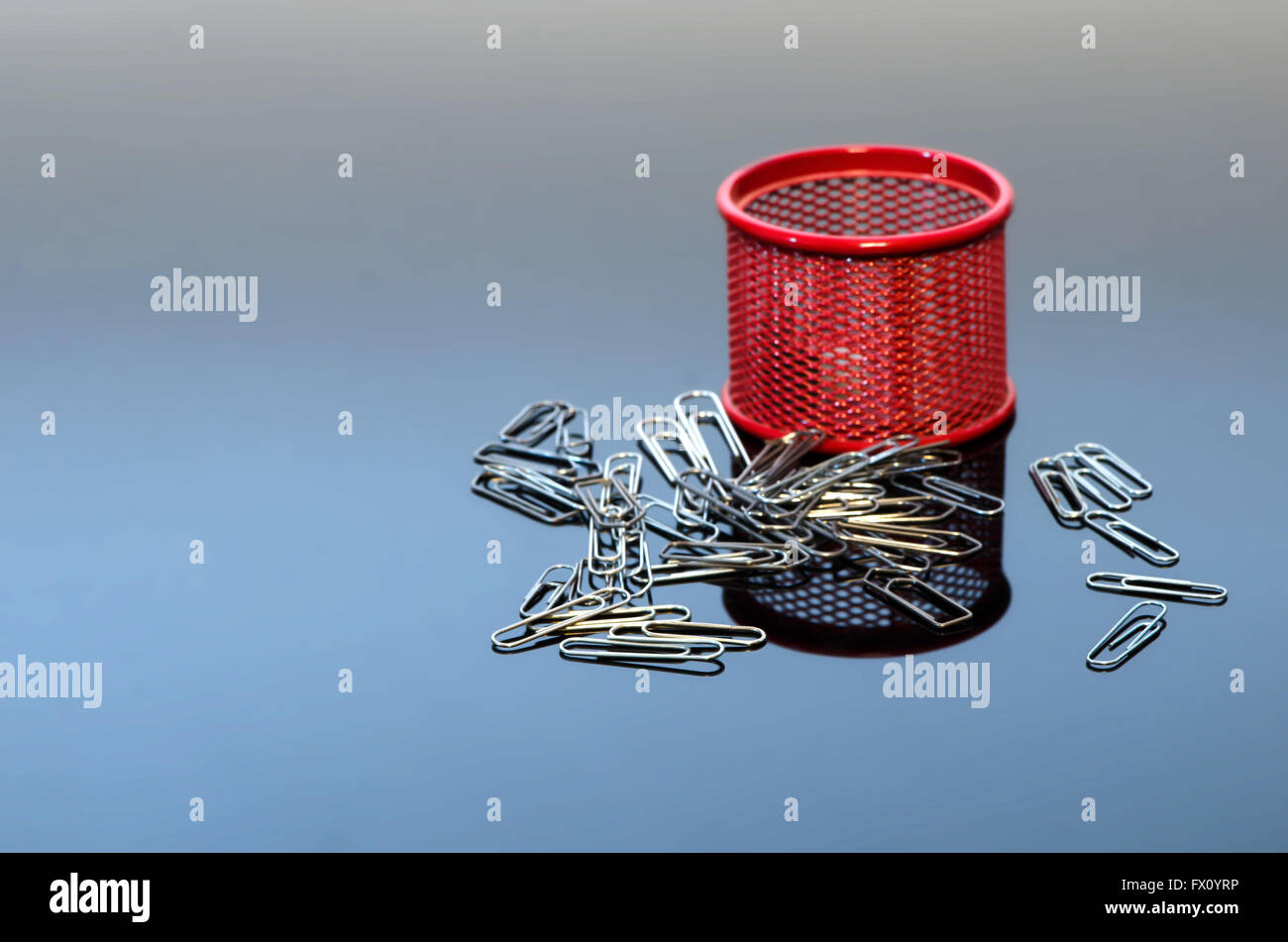 Red iron pot and heap of paper clips Stock Photo - Alamy