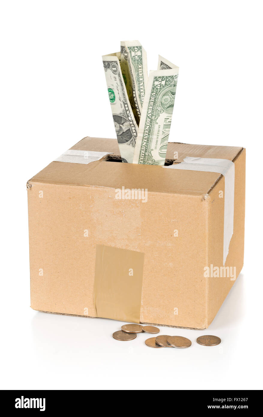 Donation carton box with dollar bills and coins over white background ...