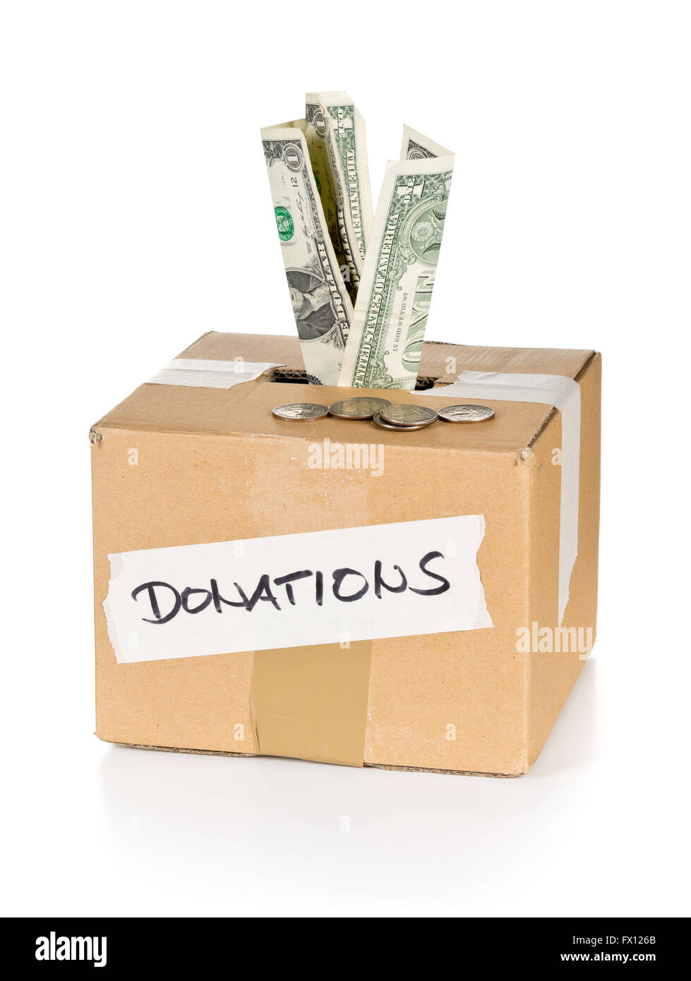 Donation carton box with dollar bills and coins over white background ...
