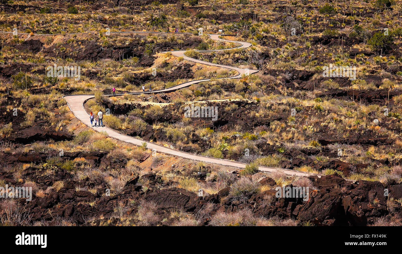 Visitors on the curved walkway through lava fields at Valley of Fires ...