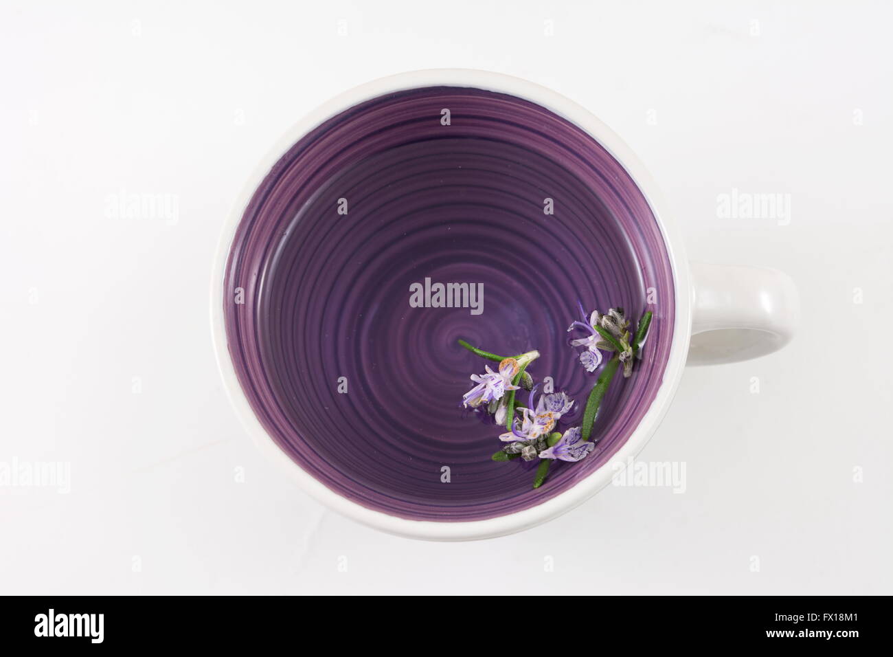 Rosemary tea with fresh rosemary flowers scattered Stock Photo - Alamy